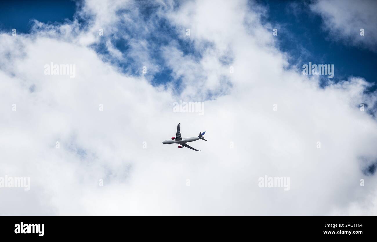 Low angle shot of an airplane under the breathtaking cloudy sky Stock ...