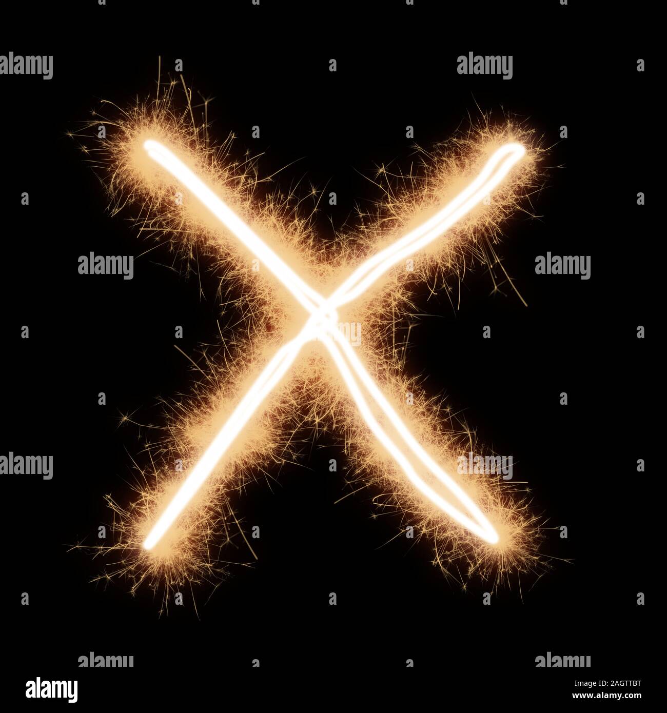 Lower case x letter of alphabet written by squib sparks on a black ...