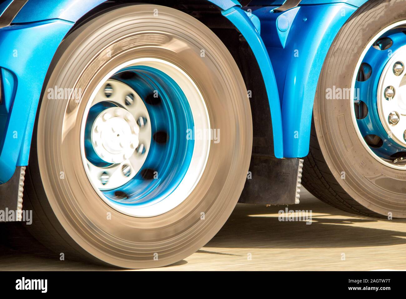A closeup of wheels in motion from an articulated lorry, travelling ...