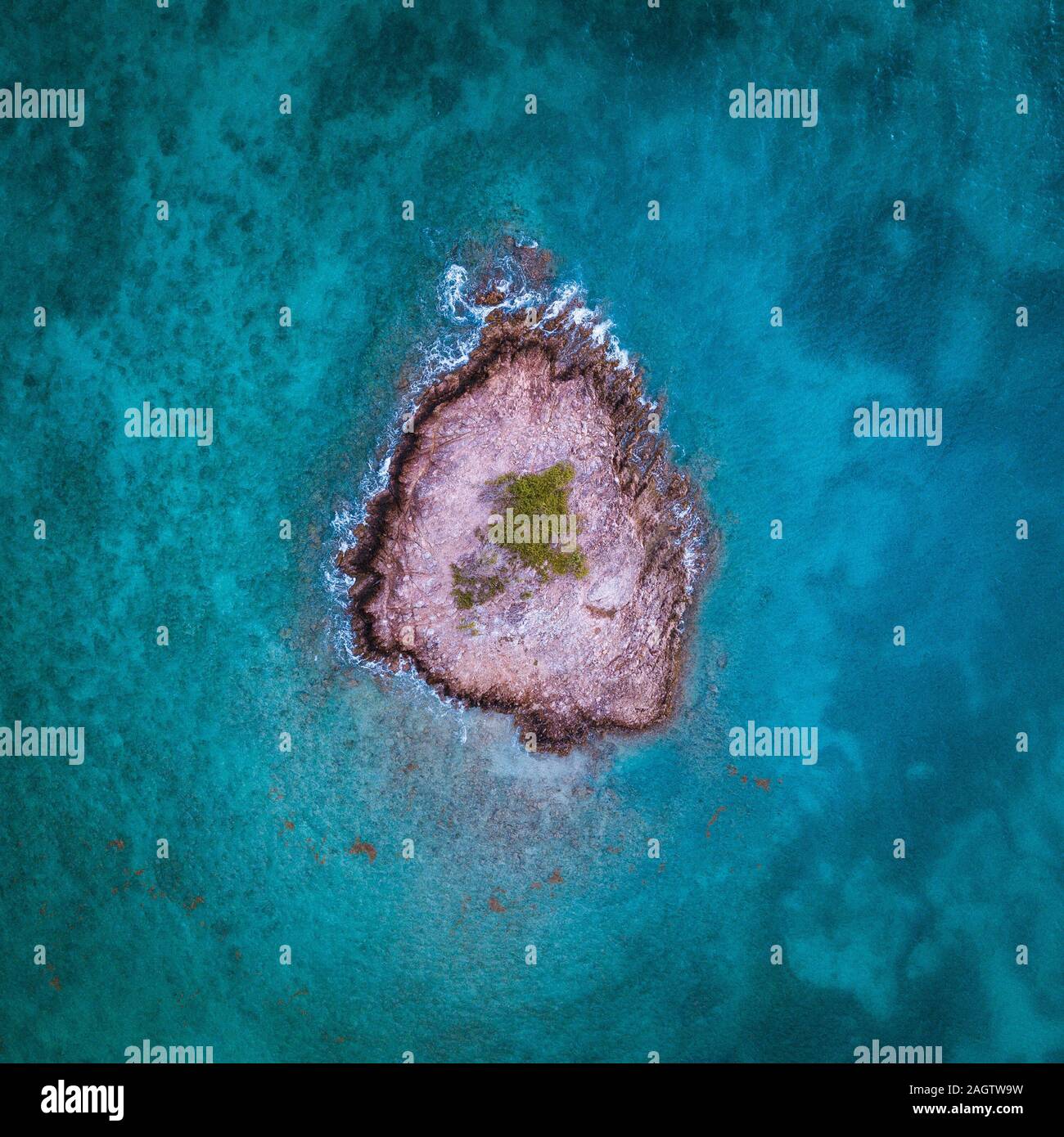 Aerial photo of deserted rocky island in turquoise water Stock Photo ...