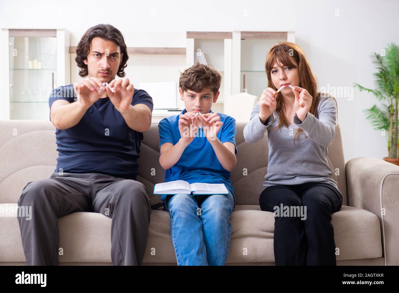 The concept of underage smoking with young boy and family Stock Photo ...