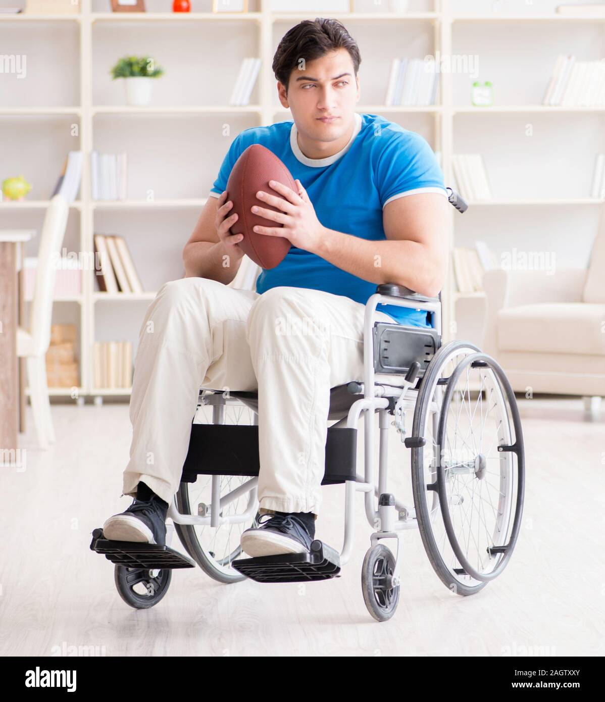 The young man american football player recovering on wheelchair Stock ...