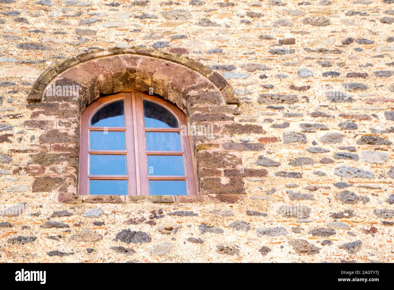 A single window on the side of a historic building. The window either ...