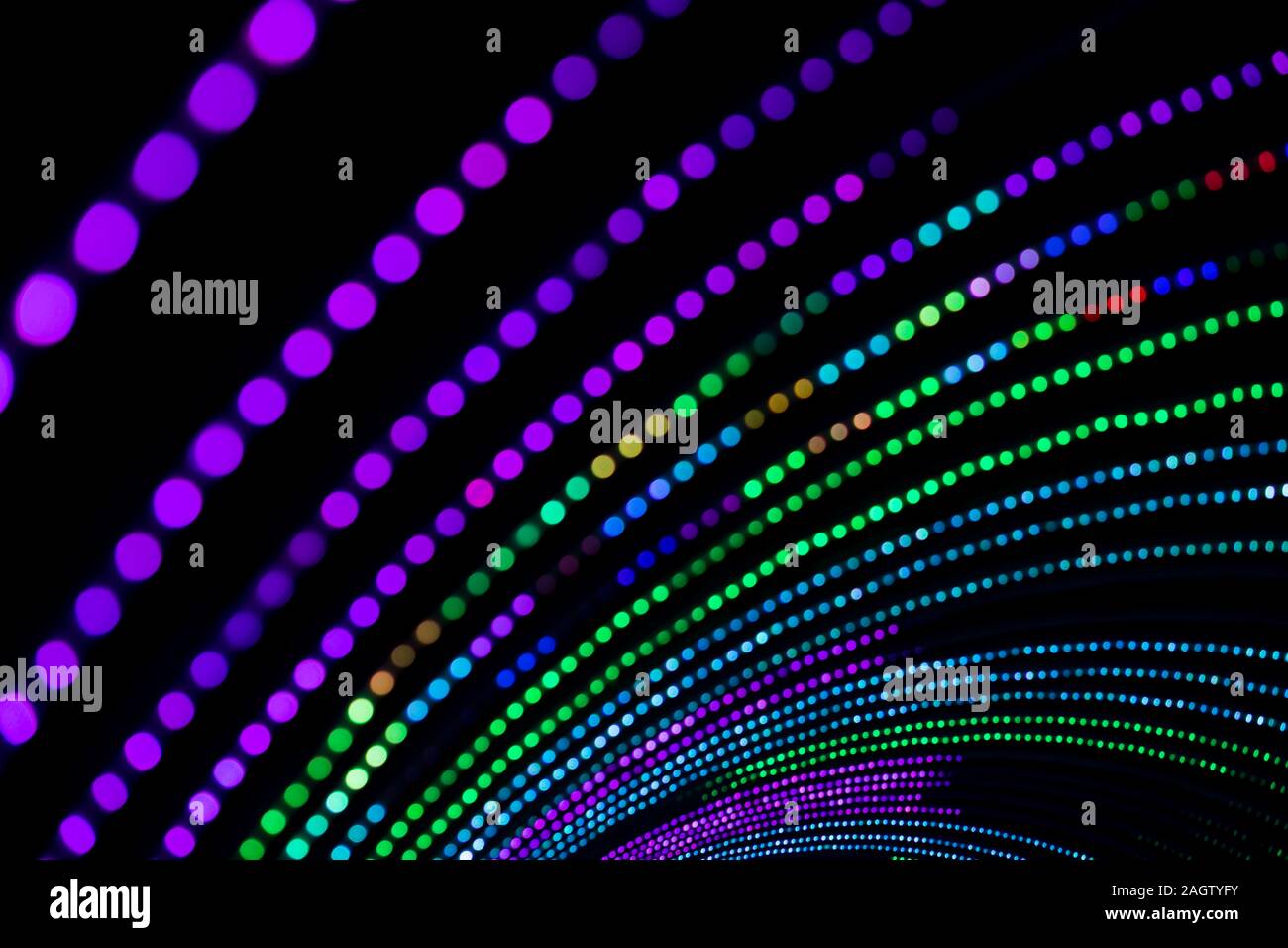 A tunnel of multi coloured lights lit up at night in an intentional out ...