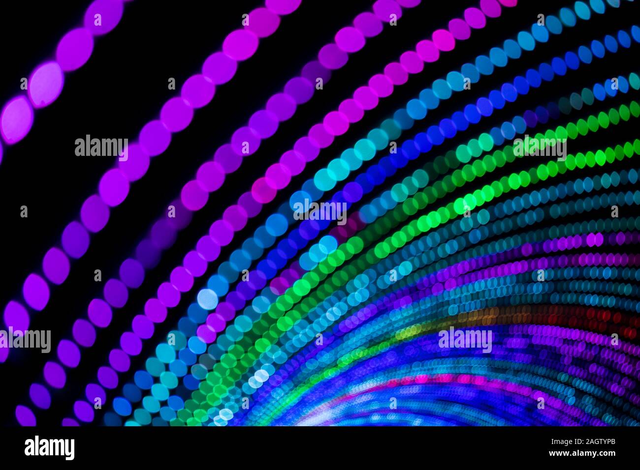 A tunnel of multi coloured lights lit up at night in an intentional out ...