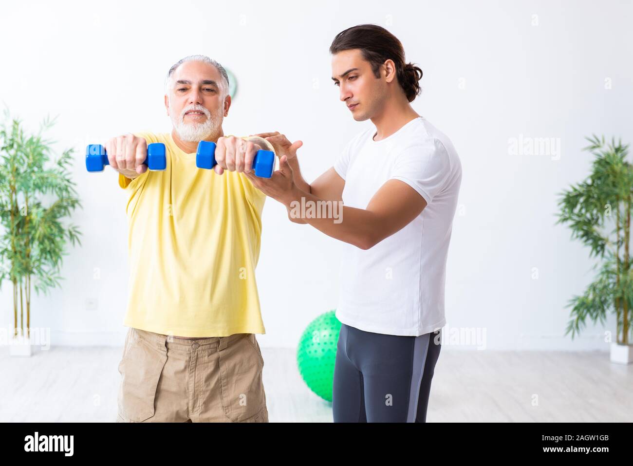 Senior man is doing rehab exercises at home hi-res stock photography ...