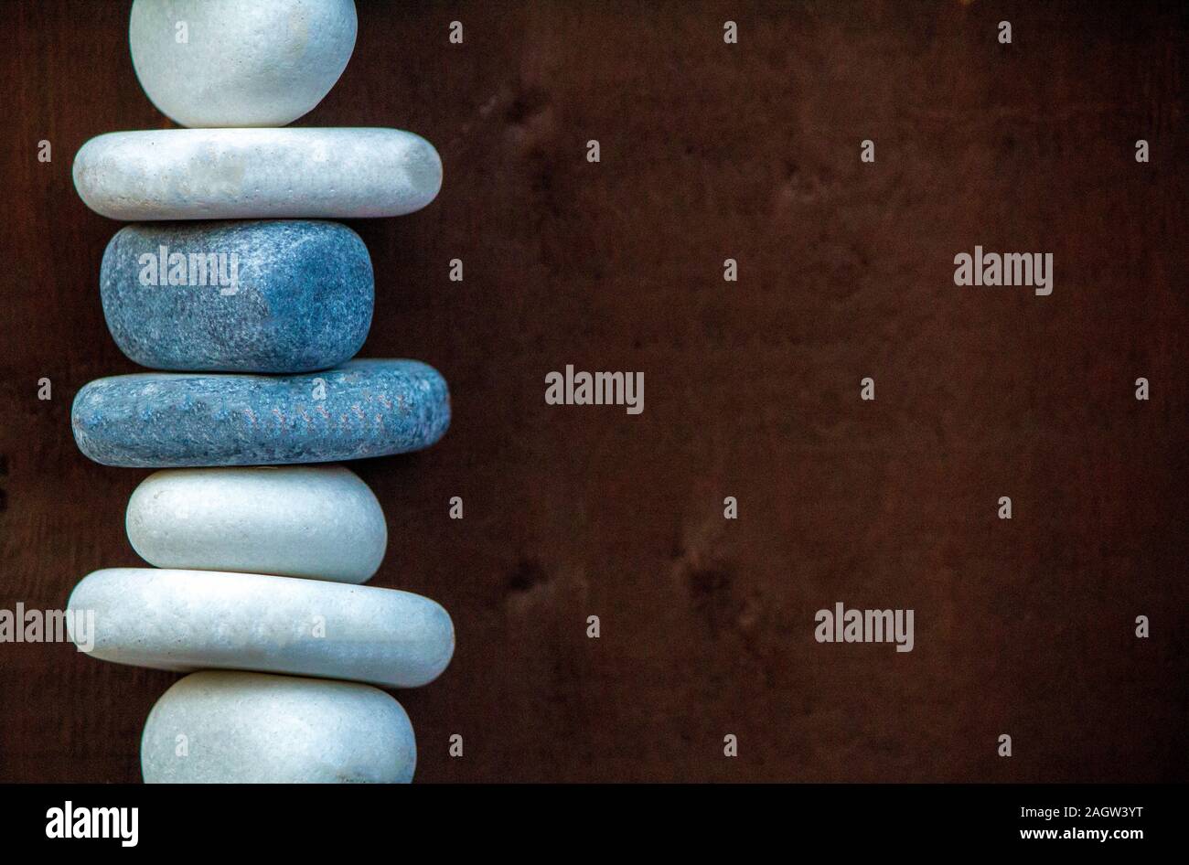 A stack, from top of frame to bottom, of smooth stones / rocks against ...