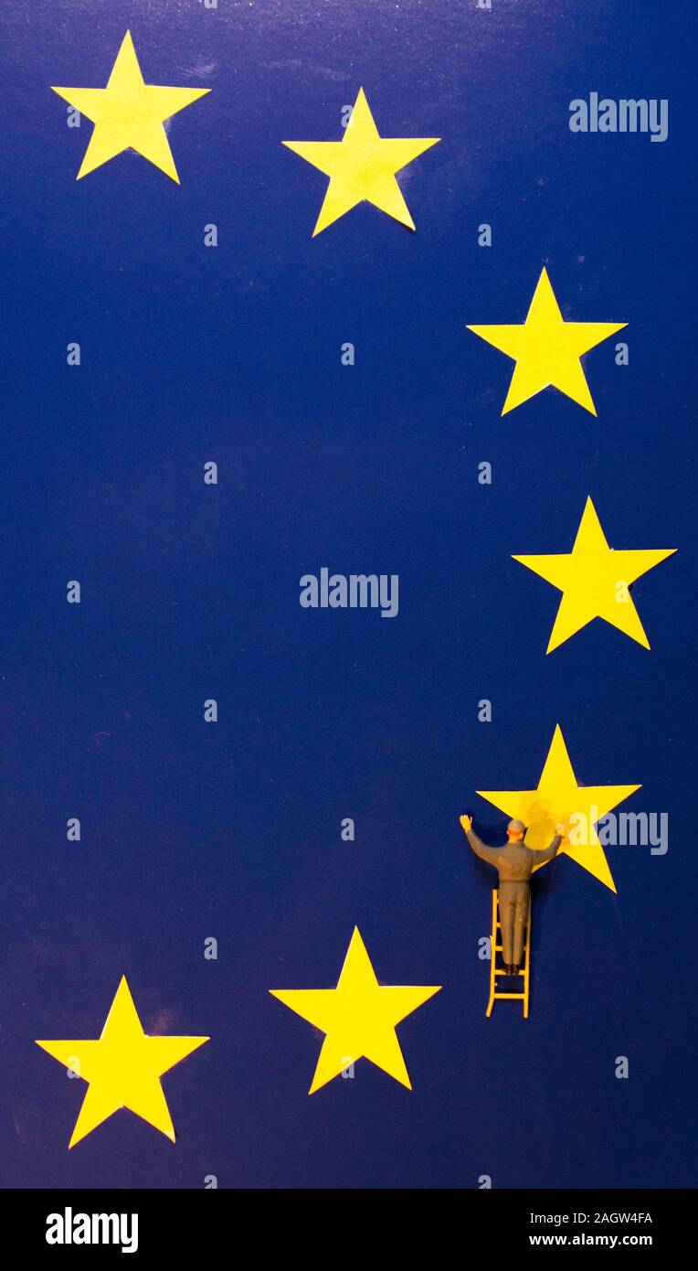 A painter adds/removes the UK's yellow star from the EU flag Stock ...