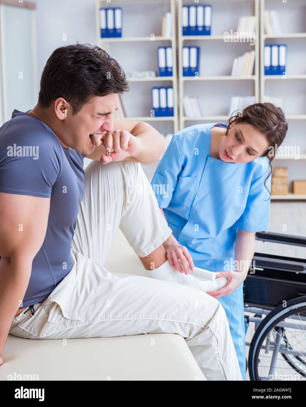 The doctor and patient during check-up for injury in hospital Stock ...