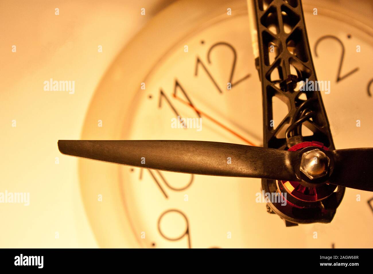 A view above a clock with the view of a drone propeller in shot Stock ...