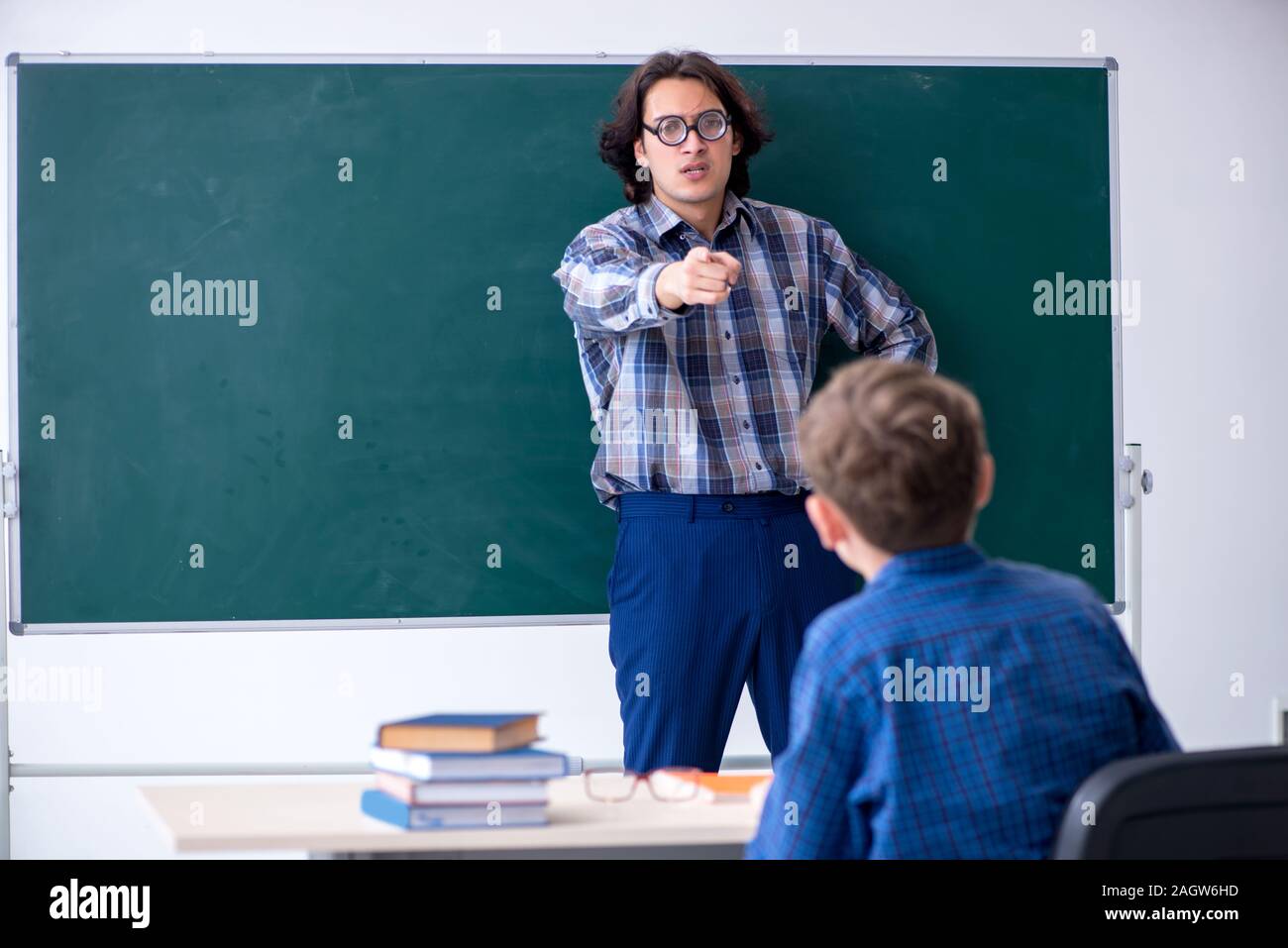 The funny male teacher and boy in the classroom Stock Photo - Alamy