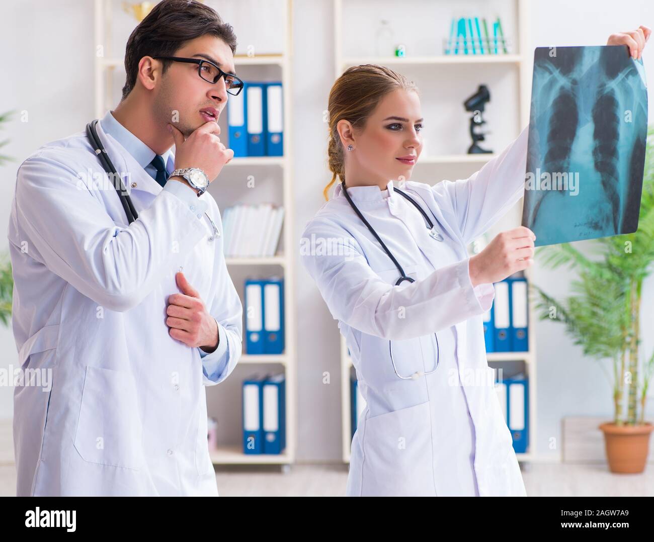 Two doctors examining x-ray images of patient for diagnosis Stock Photo ...