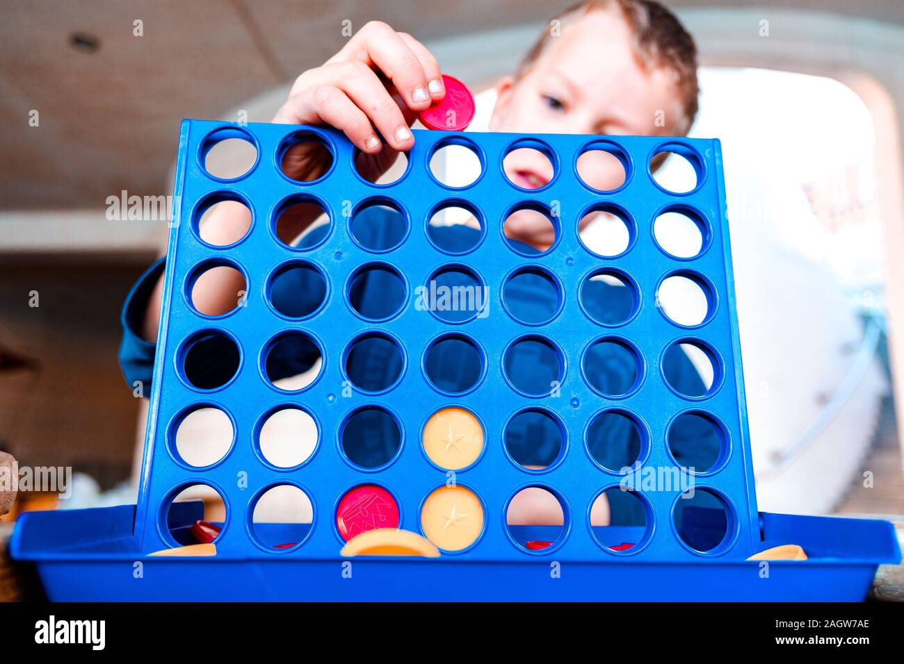 Child playing a traditional strategy game to form 4 chips row Stock ...