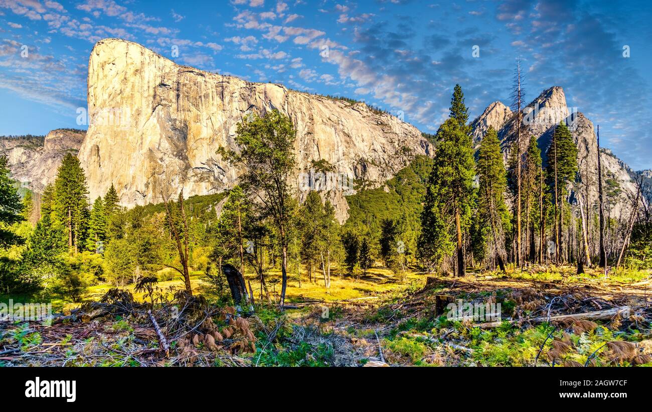 Sunrise over the large granite El Capitan rock under colorful sky ...