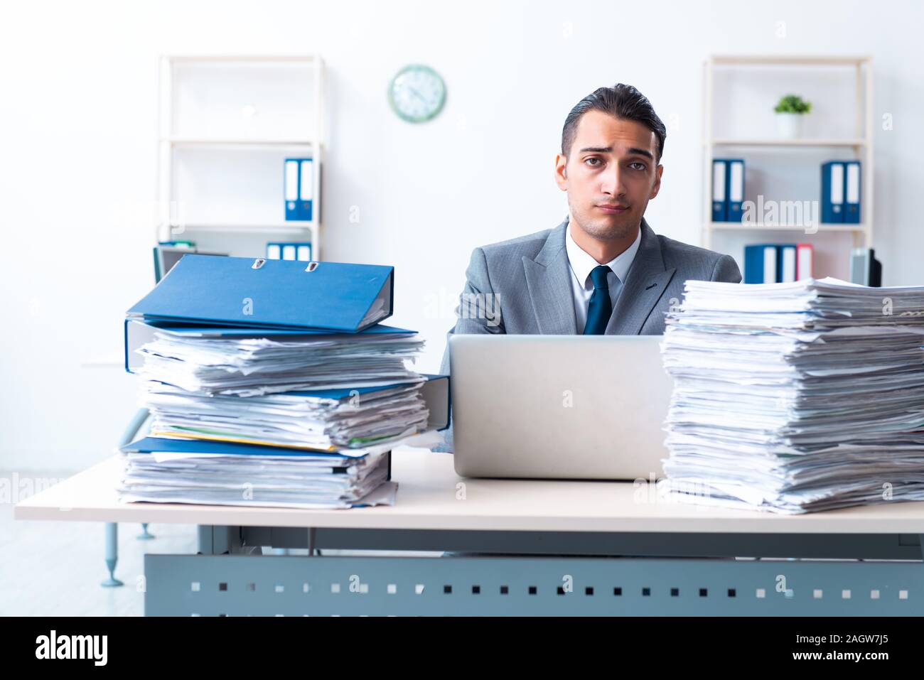 The businessman with heavy paperwork workload Stock Photo - Alamy