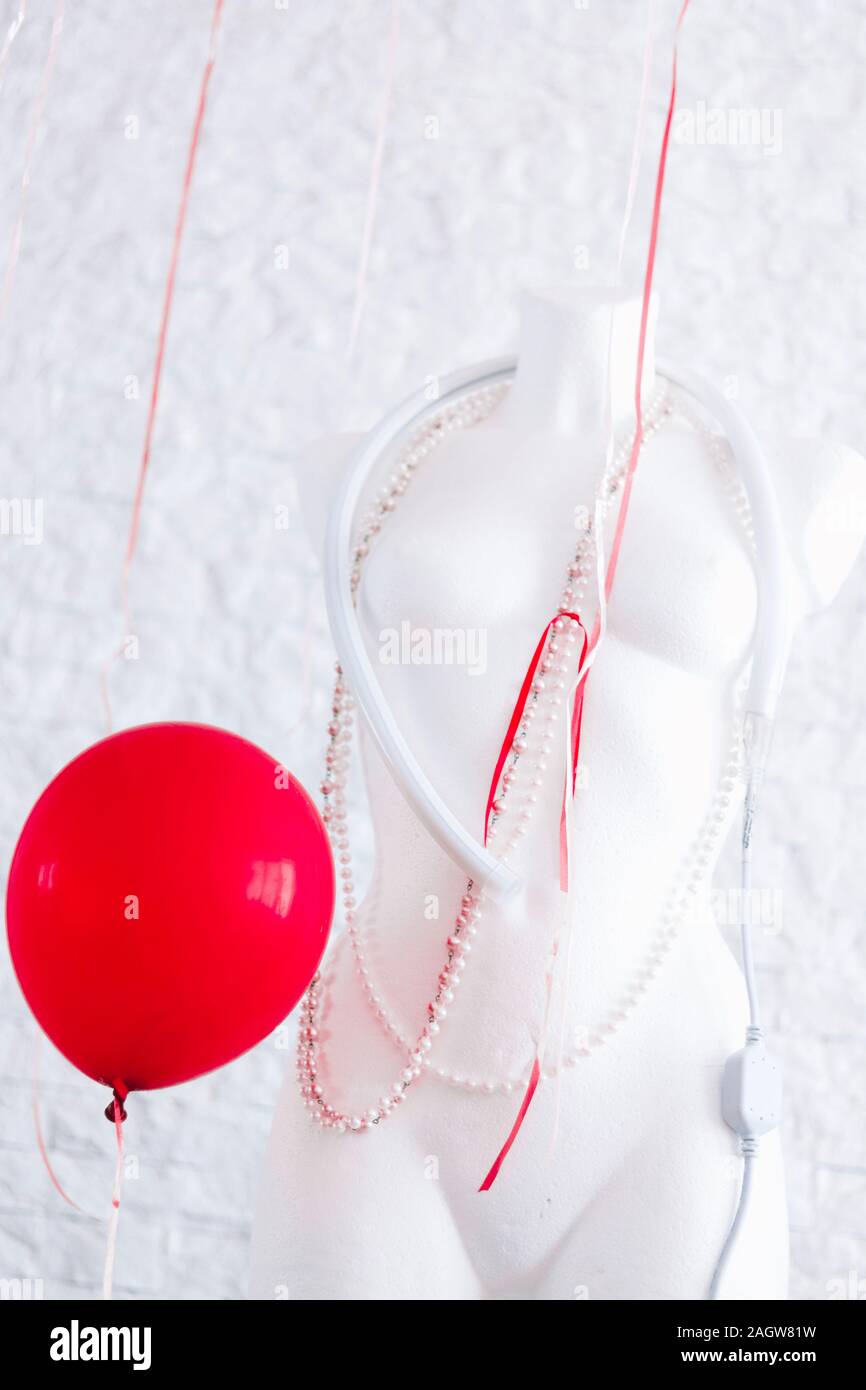 Women special days. Red ballon floating near white female mannequin for ...