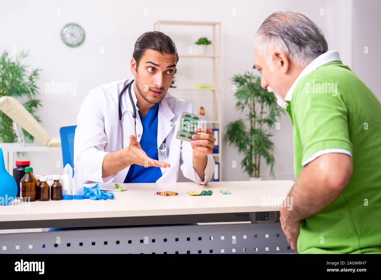 The old man visiting young male doctor gastroenterologist Stock Photo ...