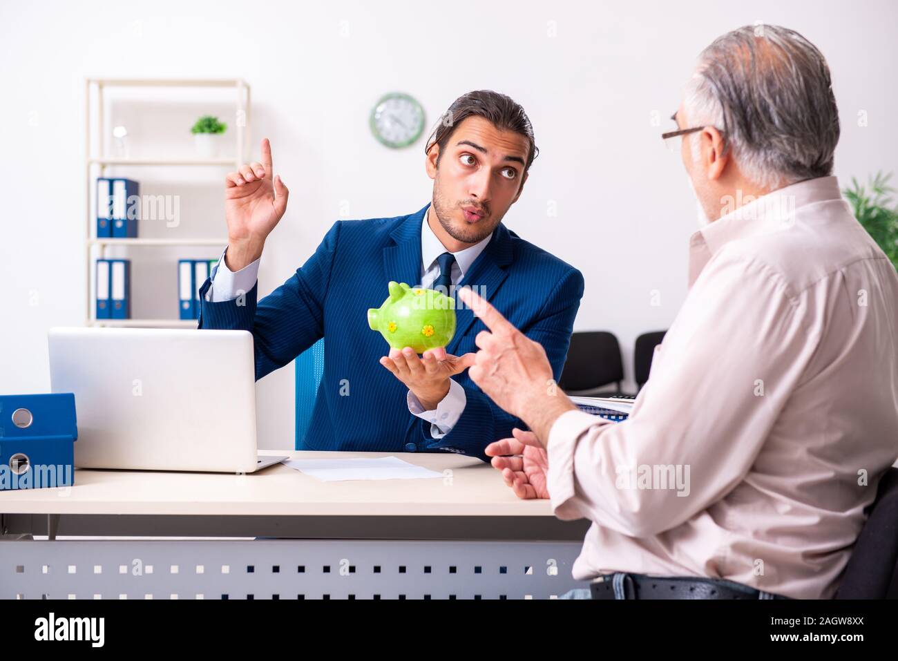 The financial advisor giving retirement advice to old man Stock Photo ...