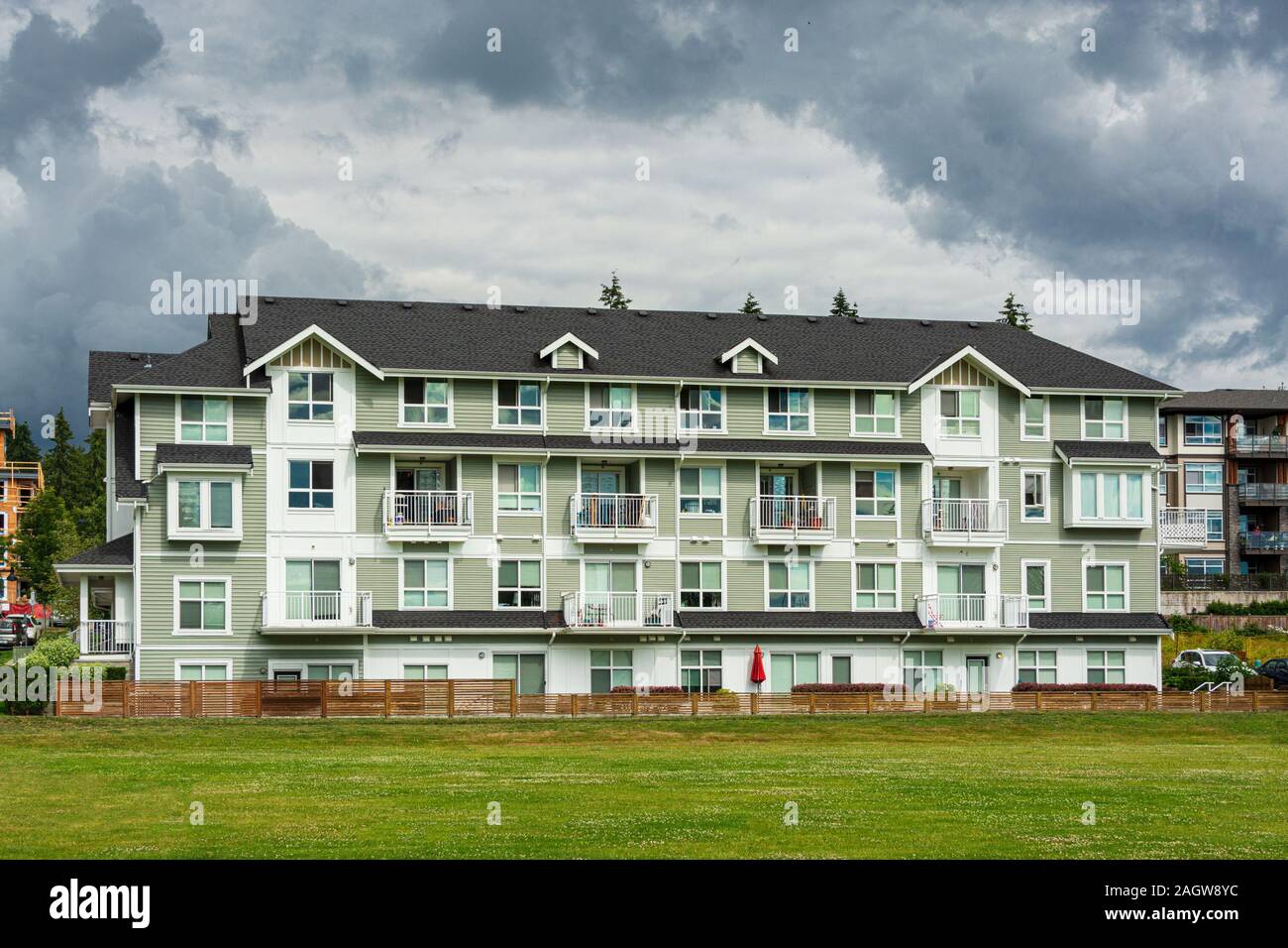 New residential low-rise building on cloudy sky background Stock Photo ...