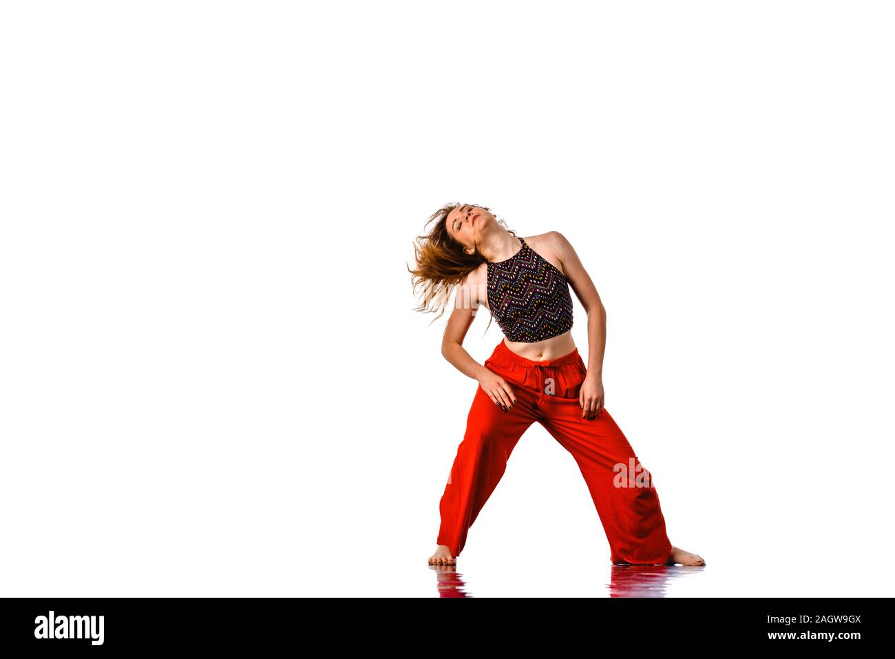 Female dancer showing some movements against isolated white background ...