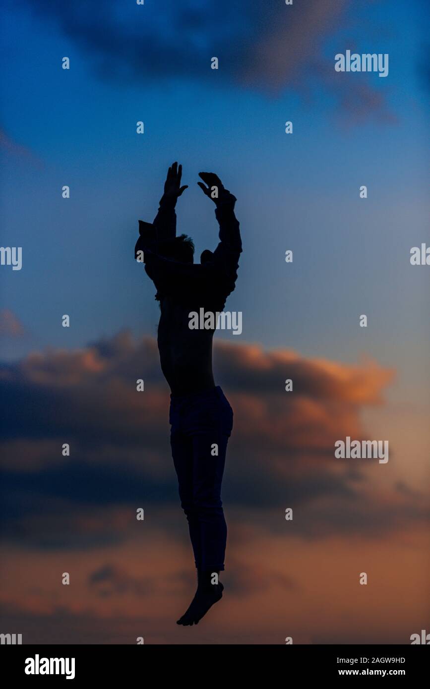 Profile view of a male urban dancer practicing some dance moves and ...
