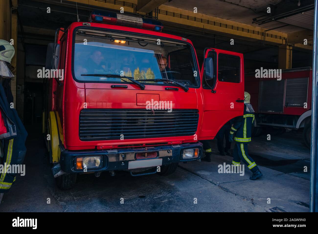 Fire engine inside the garage of the fire department Stock Photo - Alamy