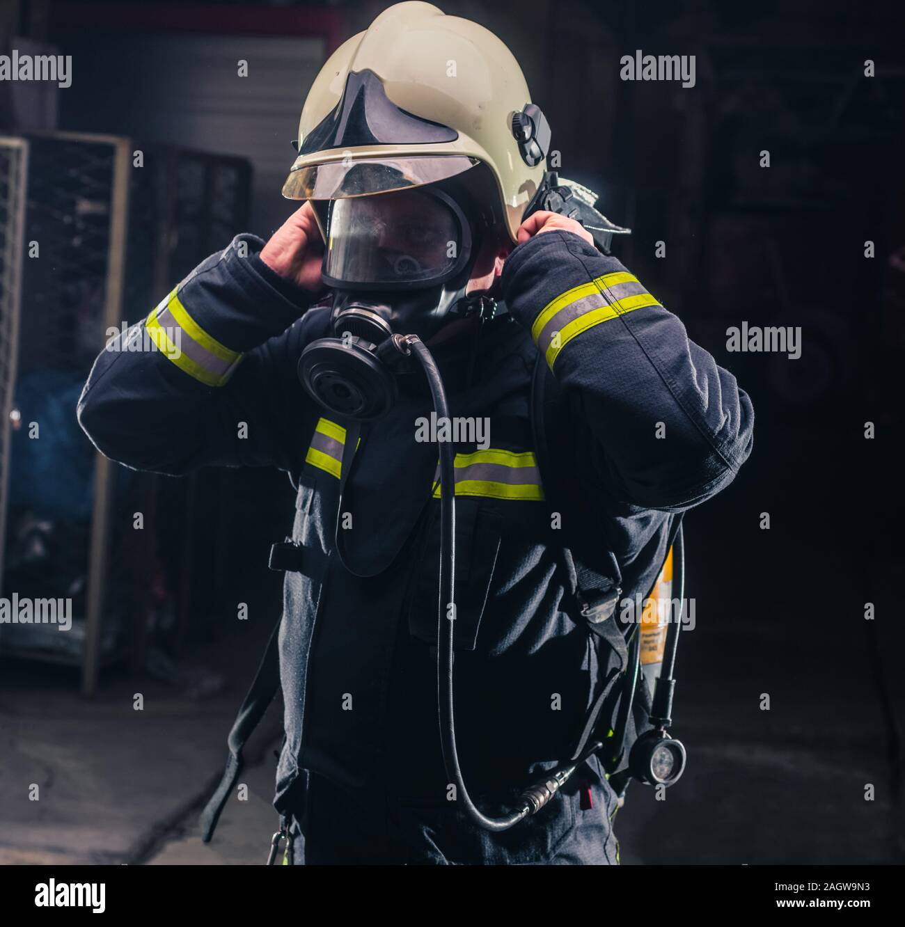 Firefighter with protective uniform wearing oxygen mask Stock Photo - Alamy