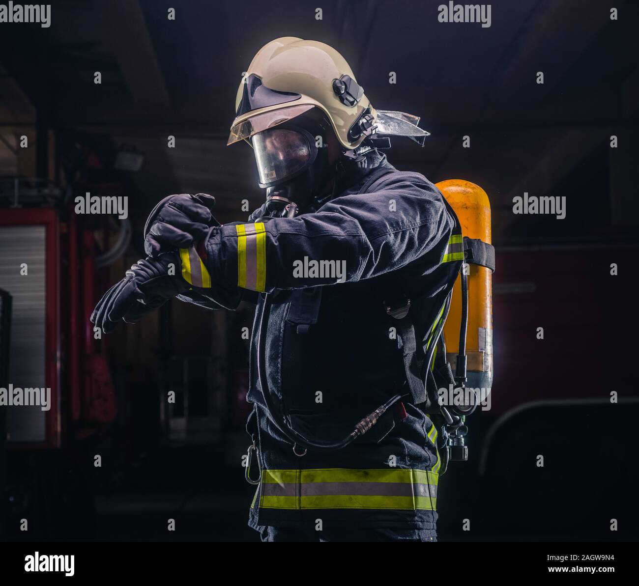 Firefighter with protective uniform wearing oxygen mask Stock Photo - Alamy