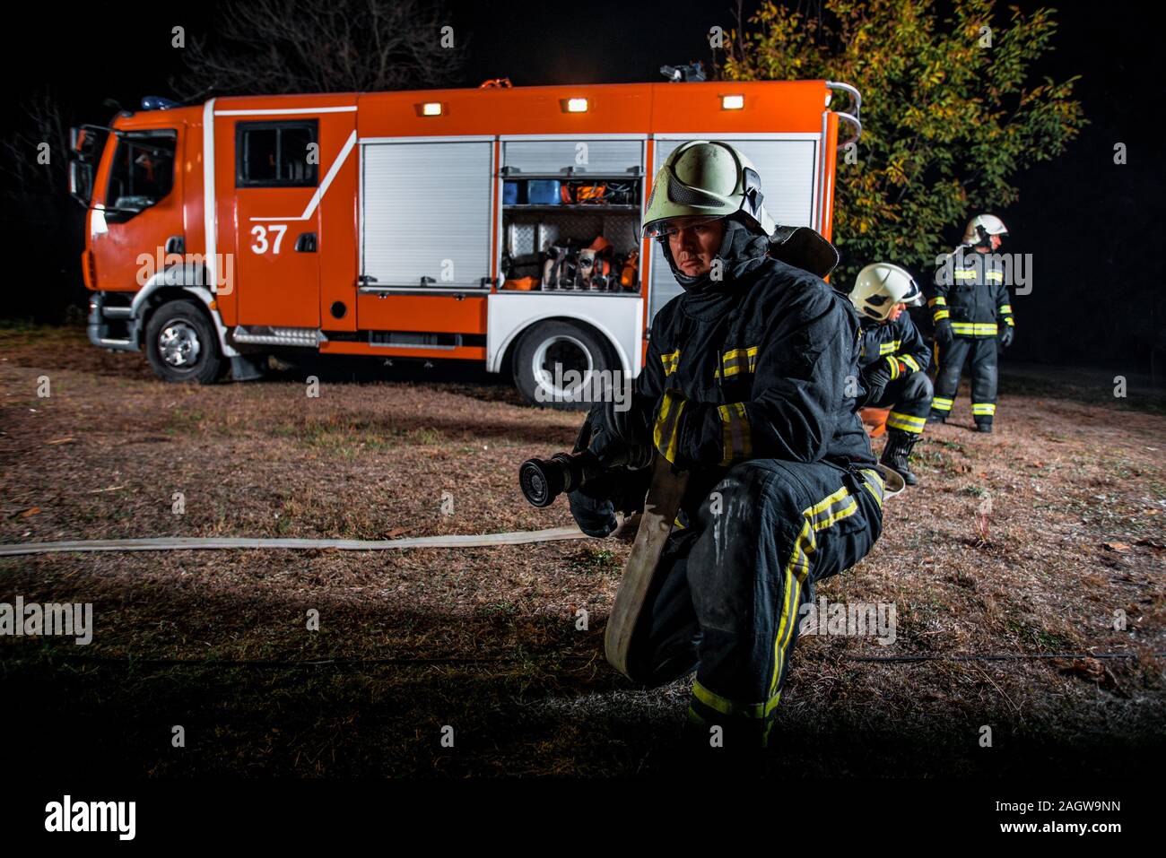 Firemen getting ready during a firefighting intervention Stock Photo ...