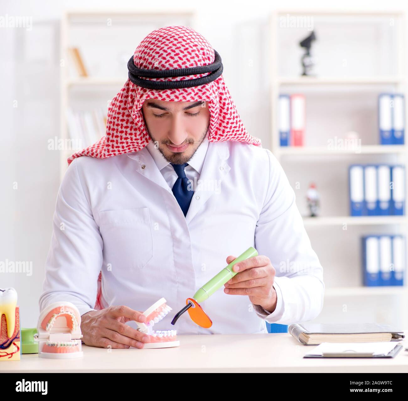 The arab dentist working on new teeth implant Stock Photo - Alamy