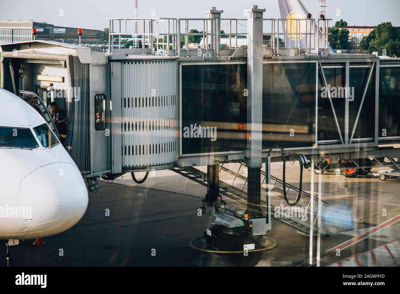 Big airplane with a jet bridge ready to be boarded by passangers at the ...