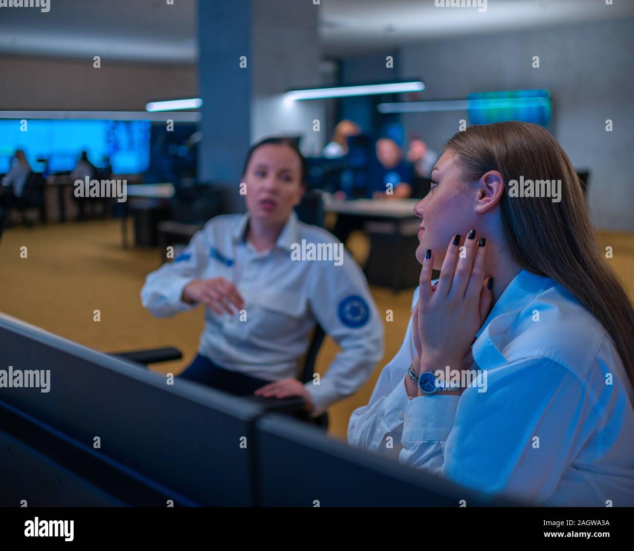 Close up photo of a security female agent monitoring the CCTV in a main ...