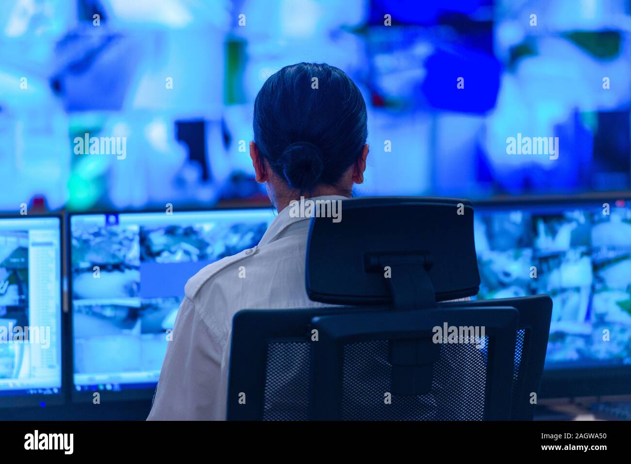 In the System Control Room, Technical Operator Works at His Workstation with Multiple Displays ...