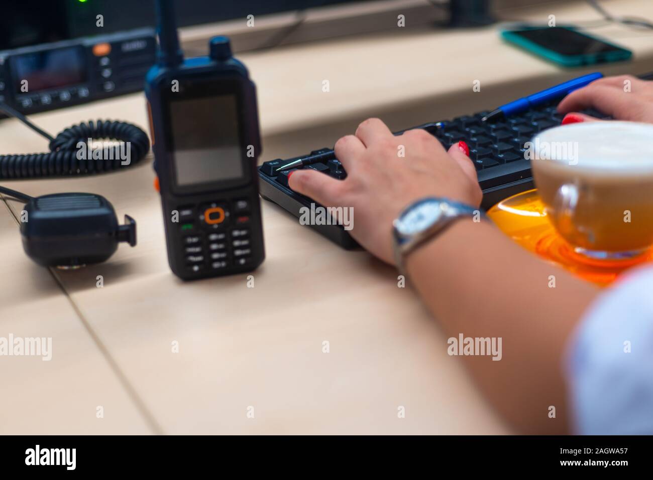 Close up photo of a security data center operator (agent )typing on her ...