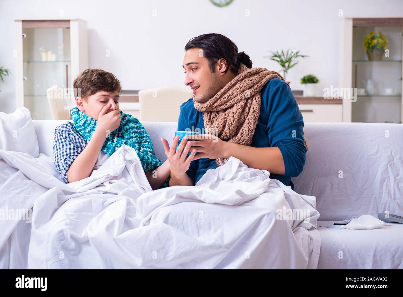 The young father caring for sick son Stock Photo - Alamy