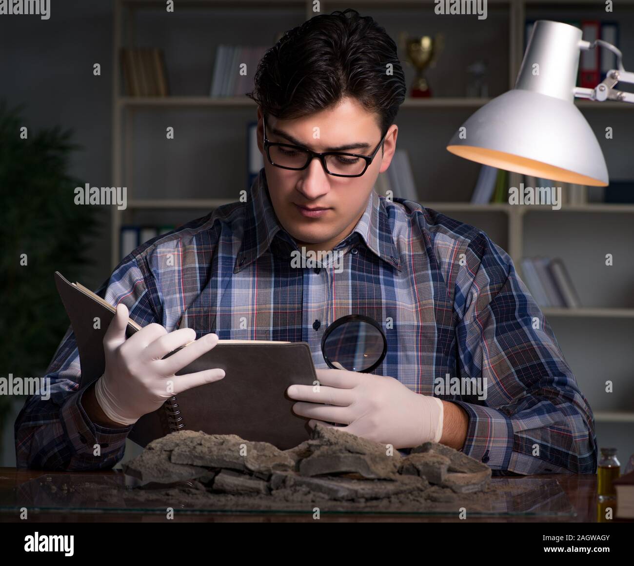 The archeologist working late night in office Stock Photo - Alamy