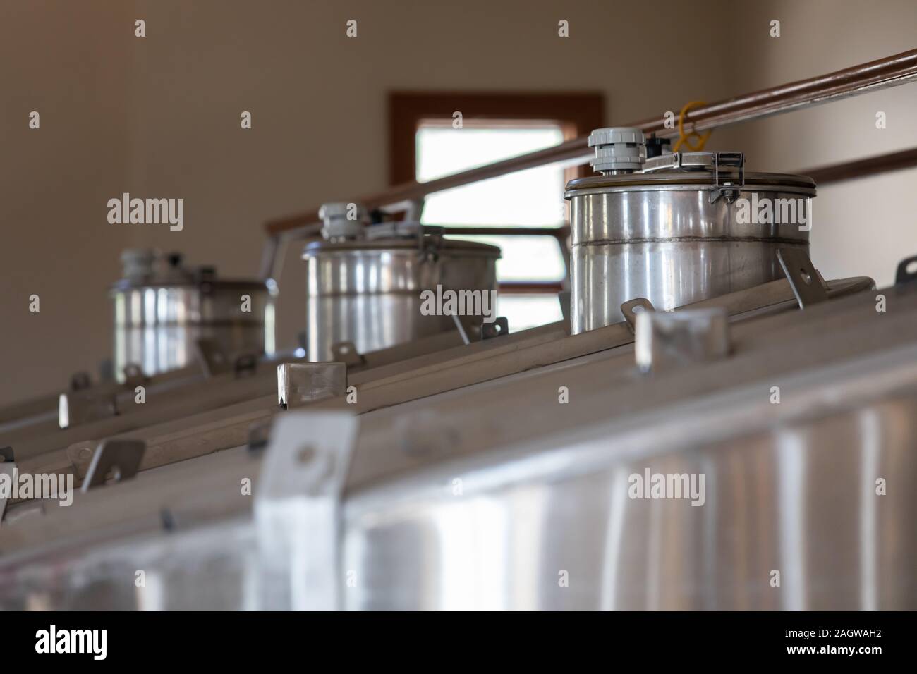 Truncated top stainless steel wine tanks access closed doors ...