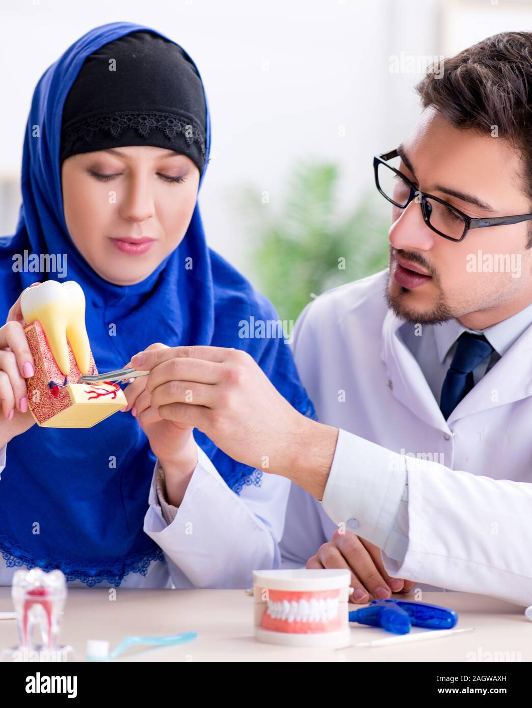 The dentist doctor and assistant working on new tooth implant Stock ...