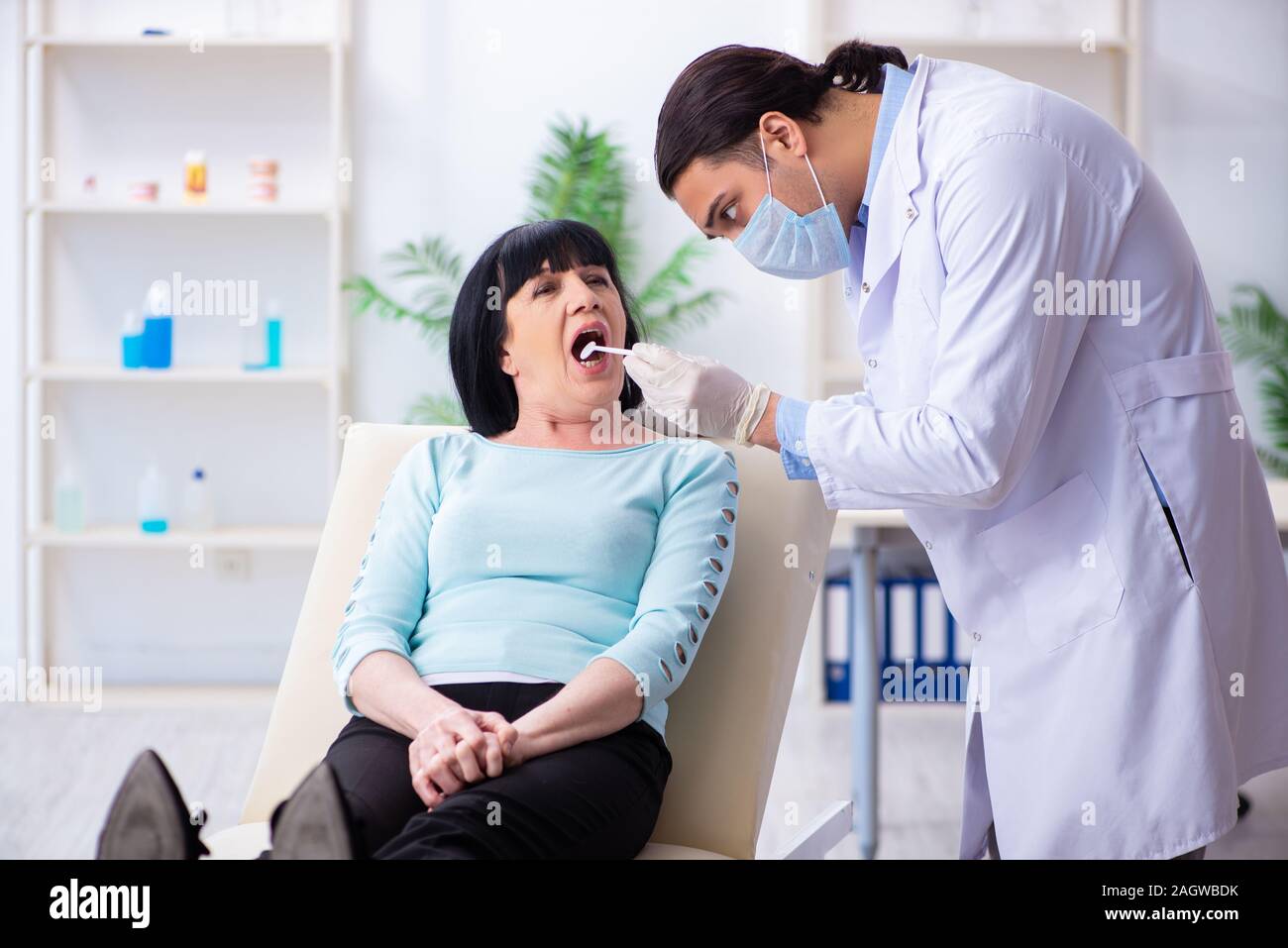 Old woman visiting young doctor dentist hi-res stock photography and ...