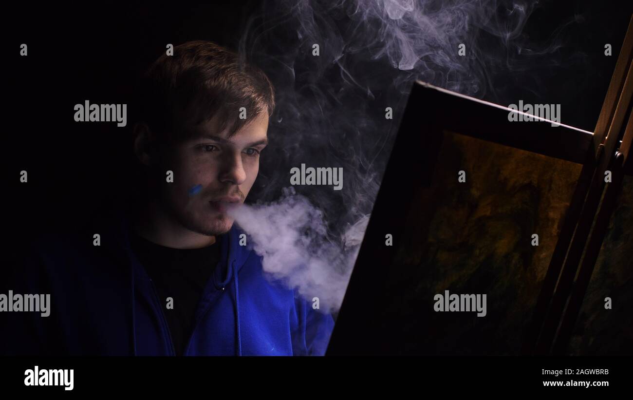 Artist copyist paint seascape with ship in ocean. Vaper smoke vape e ...