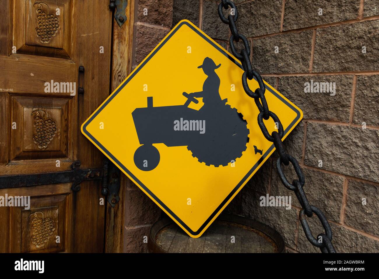 Tractor crossing warning road sign used as decor with Metal chain on ...