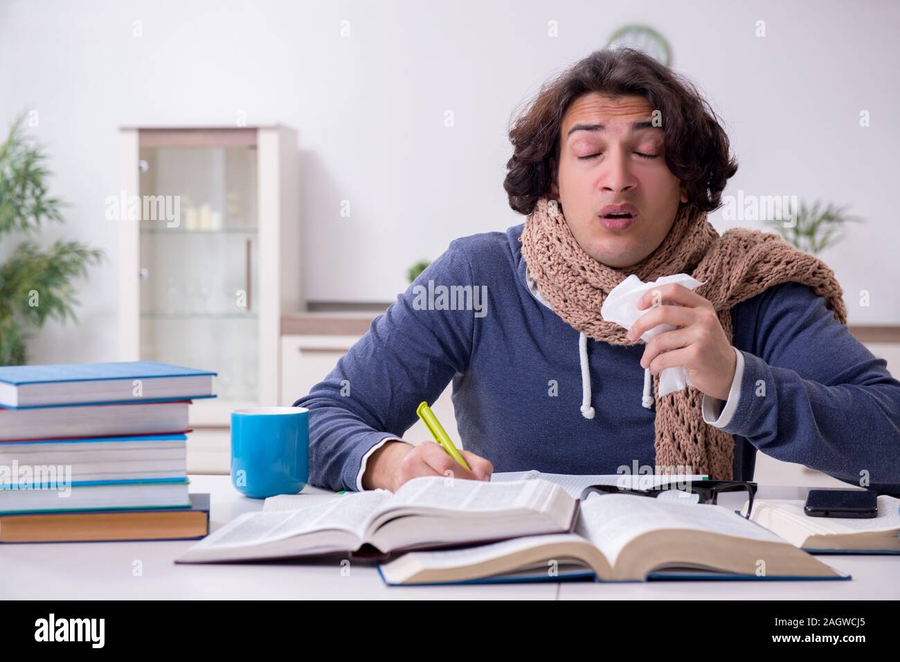 The sick male student suffering at home Stock Photo - Alamy