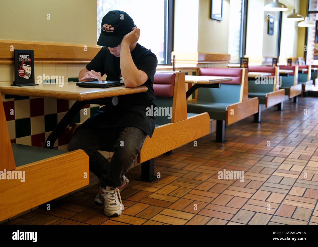 Cromwell, CT USA. Nov 2109. Young fast food employee taking a break at ...