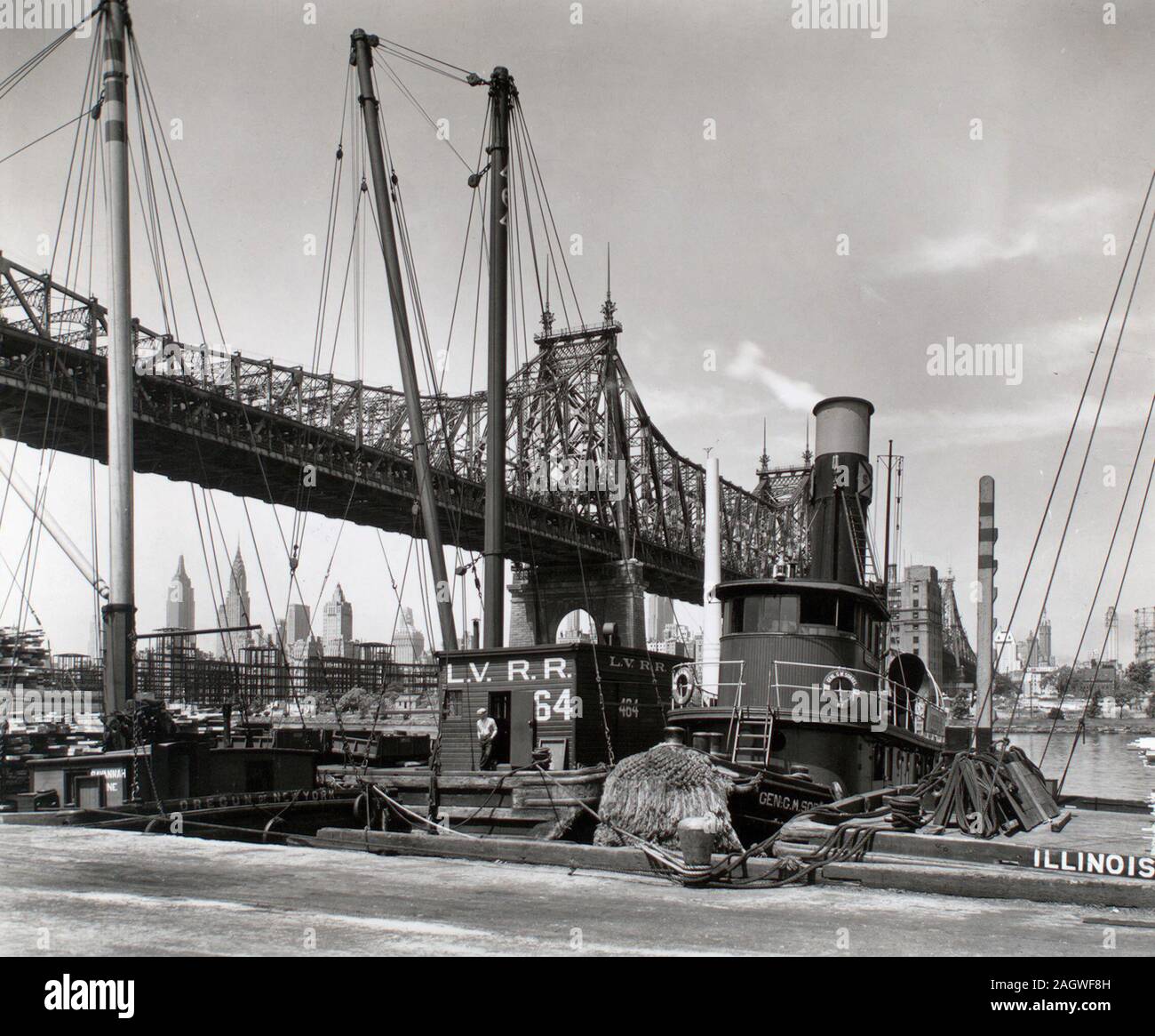 Chrysler and other Manhattan buildings visible under the bridge, boats ...