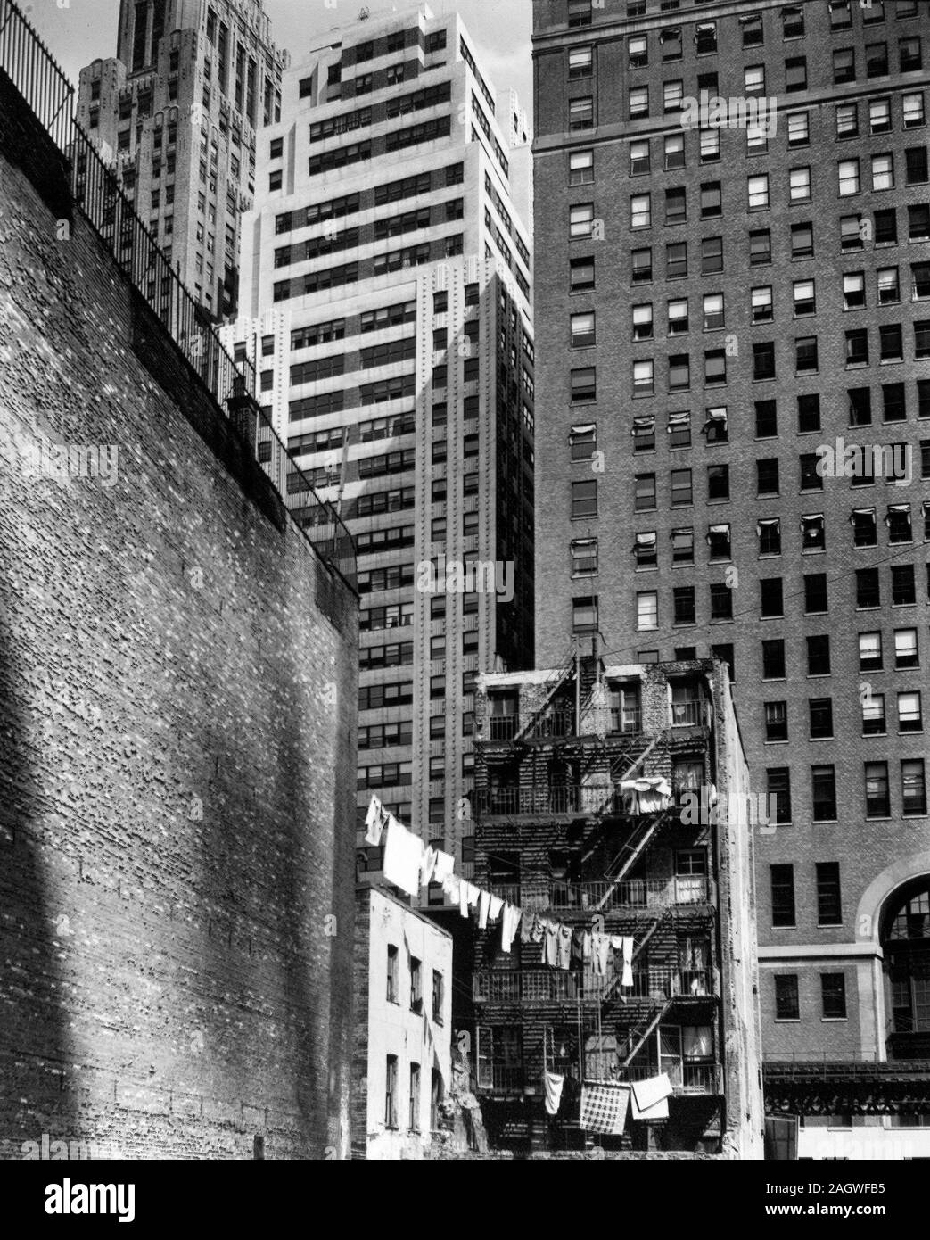 Wash hangs from lines outside 6 story tenement which is dwarfed by ...