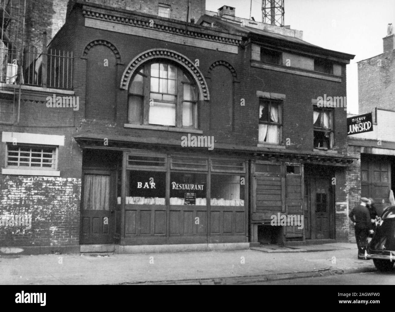 Two story bar and restaurant, small house and at far right, a junk shop ...
