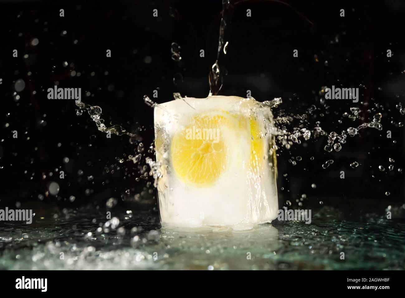 lemon in ice and falling drops of water Stock Photo - Alamy