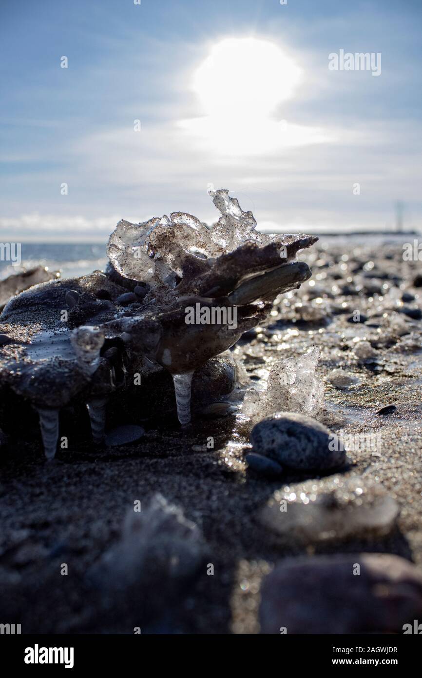 Beautiful ice shapes from objects in the beach Stock Photo - Alamy