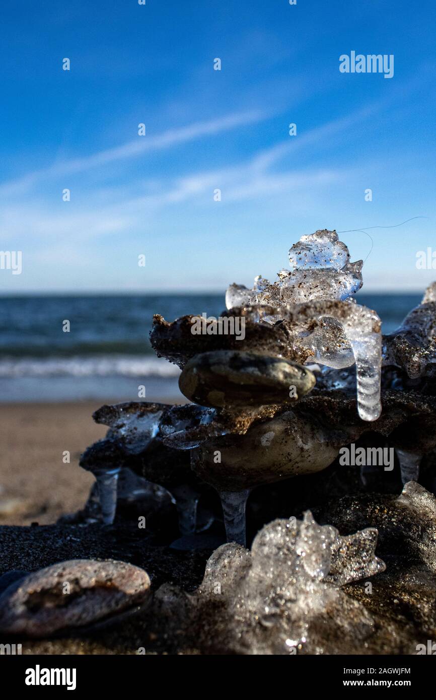 Beautiful ice shapes from objects in the beach Stock Photo - Alamy