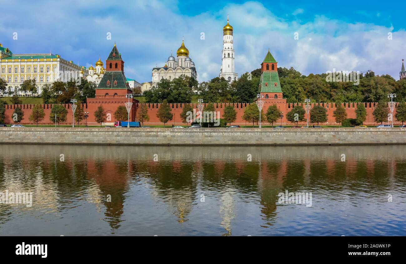 Daytime view of the red Kremlin wall, tower and golden onion domes of ...